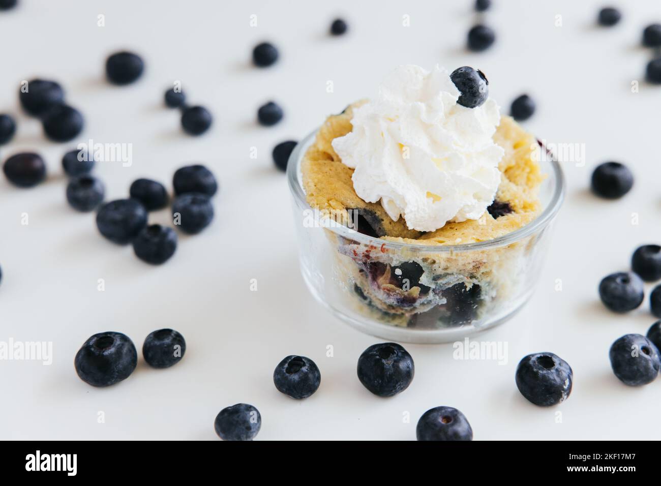 a closeup of a blueberry dessert in a small bowl on white surface Stock ...