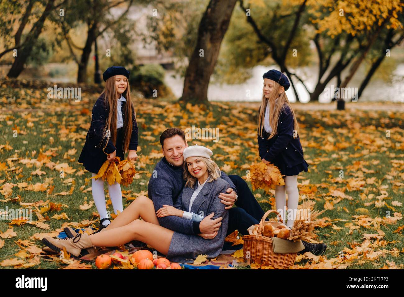 A big family on a picnic in the fall in a nature park. Happy people in ...