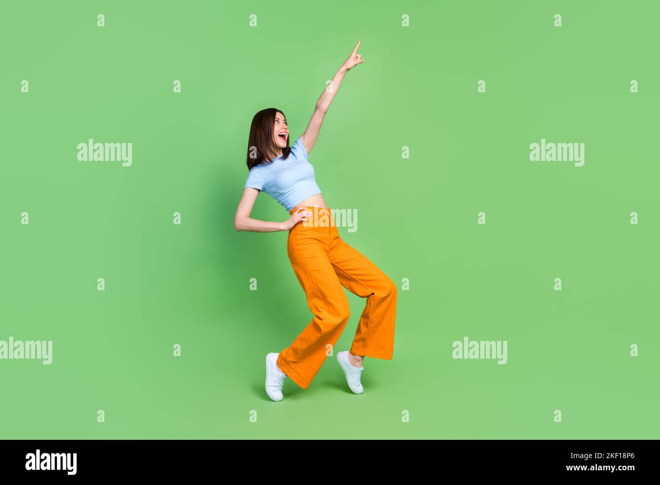 Full size photo of crazy positive girl raise hand point finger enjoy ...