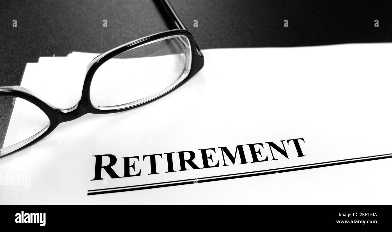 Retirement planning documents on desk with glasses for plan to retire ...