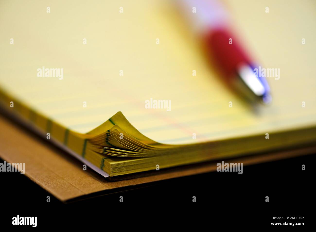 Notebook or legal pad with bent pages of paper worn edges dog earred ...