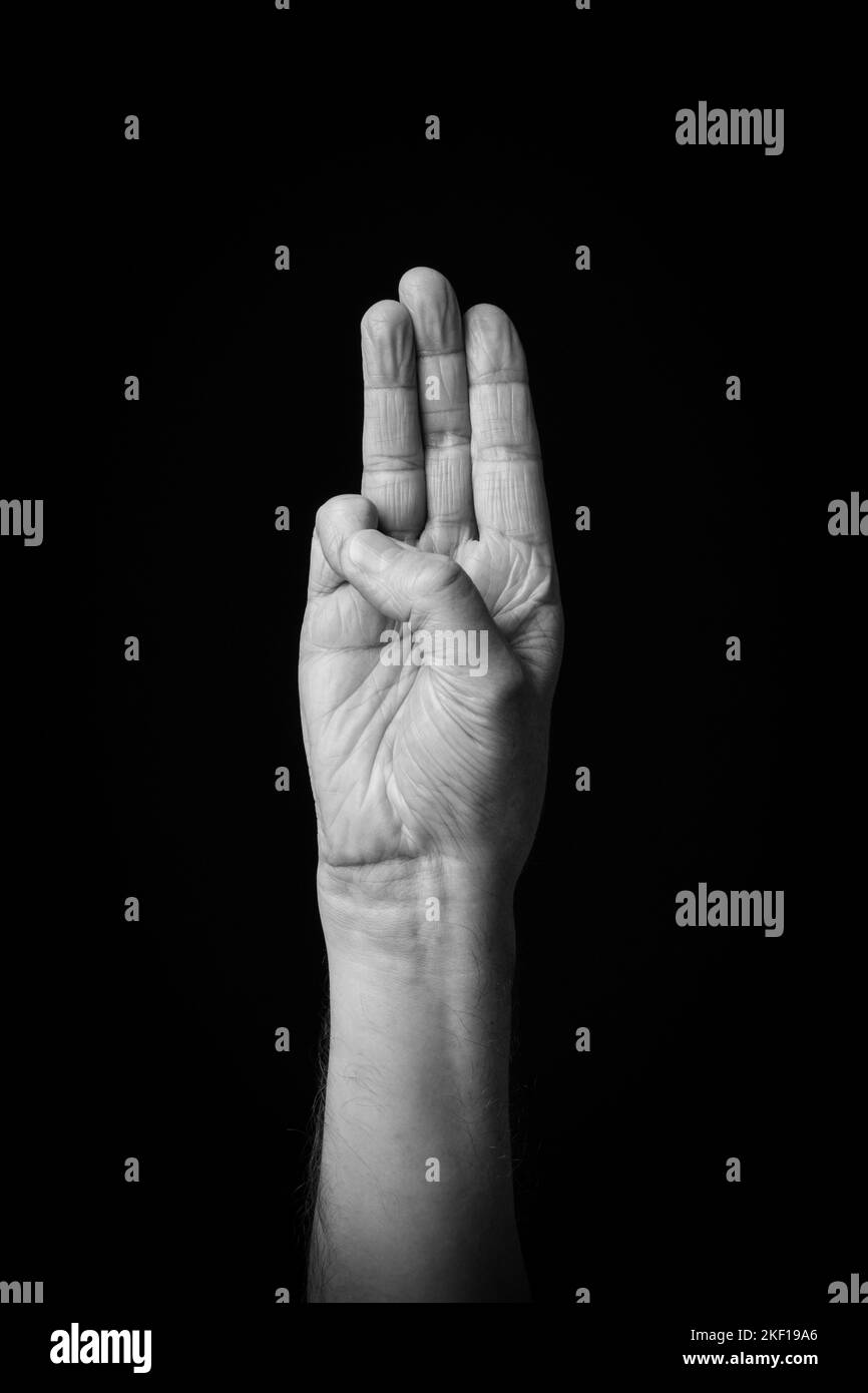 Dramatic black and white image of a male hand fingerspelling the Arabic ...