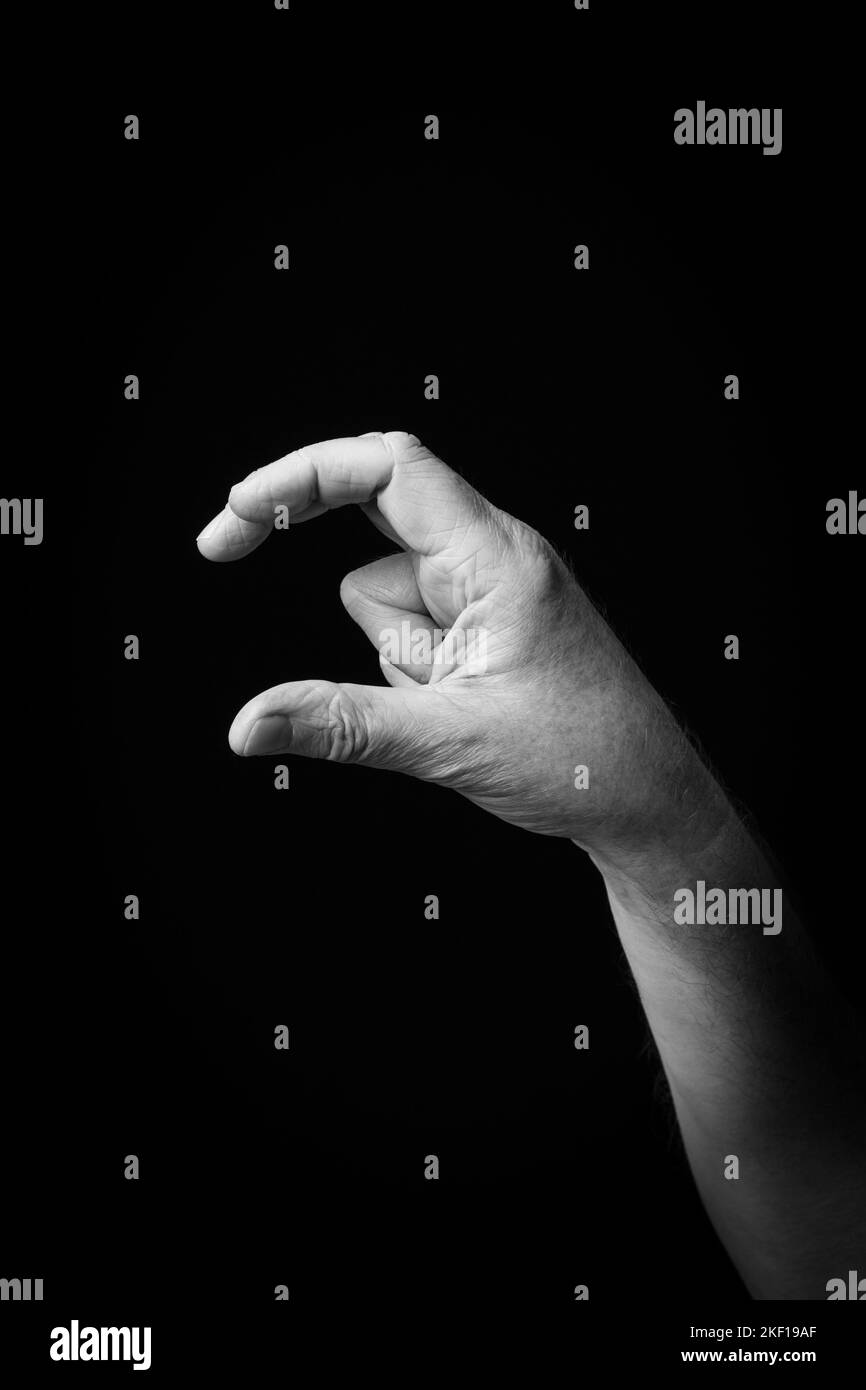 Dramatic black and white image of a male hand fingerspelling the Arabic ...
