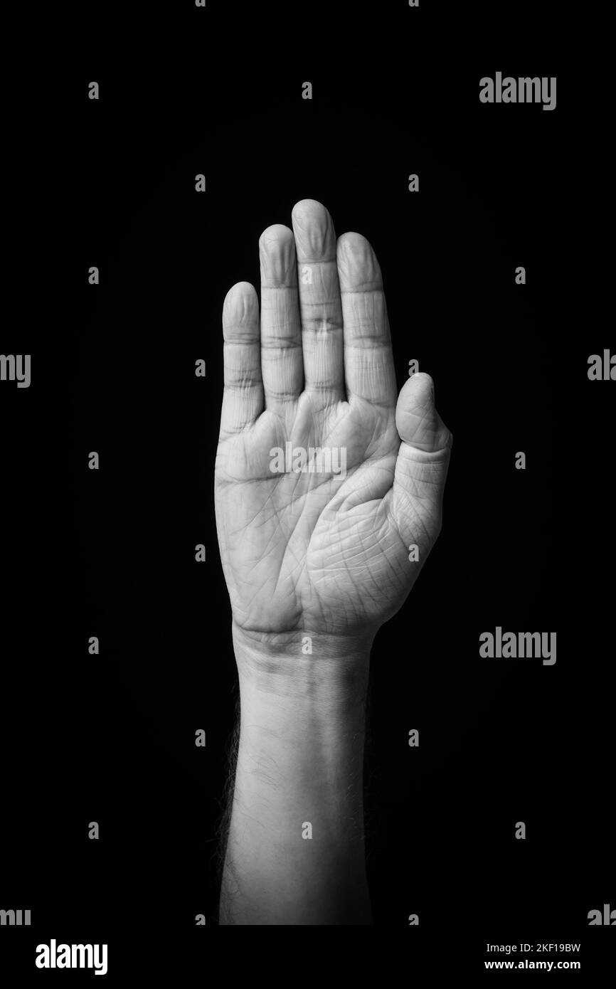 Dramatic black and white image of a male hand fingerspelling the Arabic ...