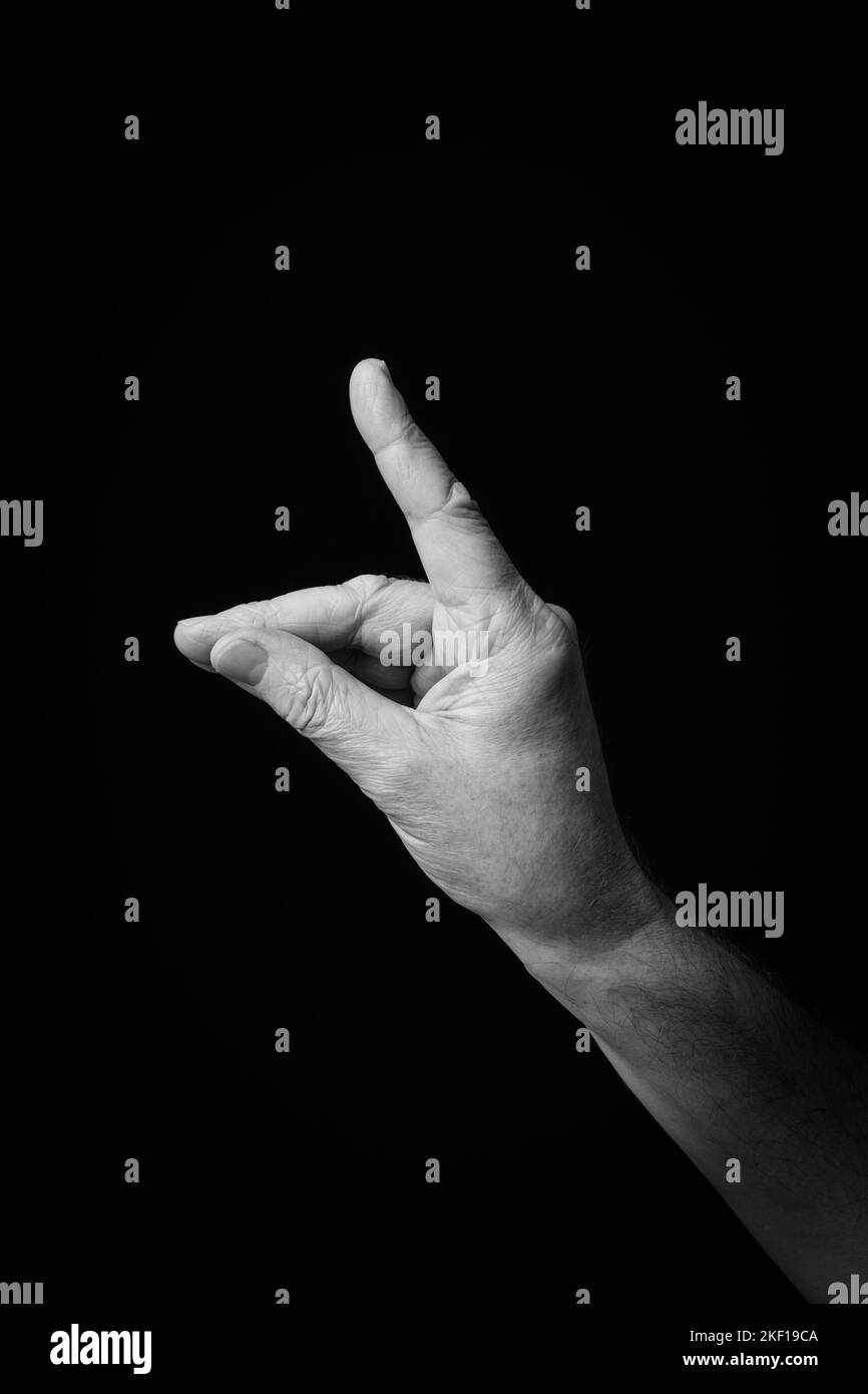 Dramatic black and white image of a male hand fingerspelling the Arabic ...