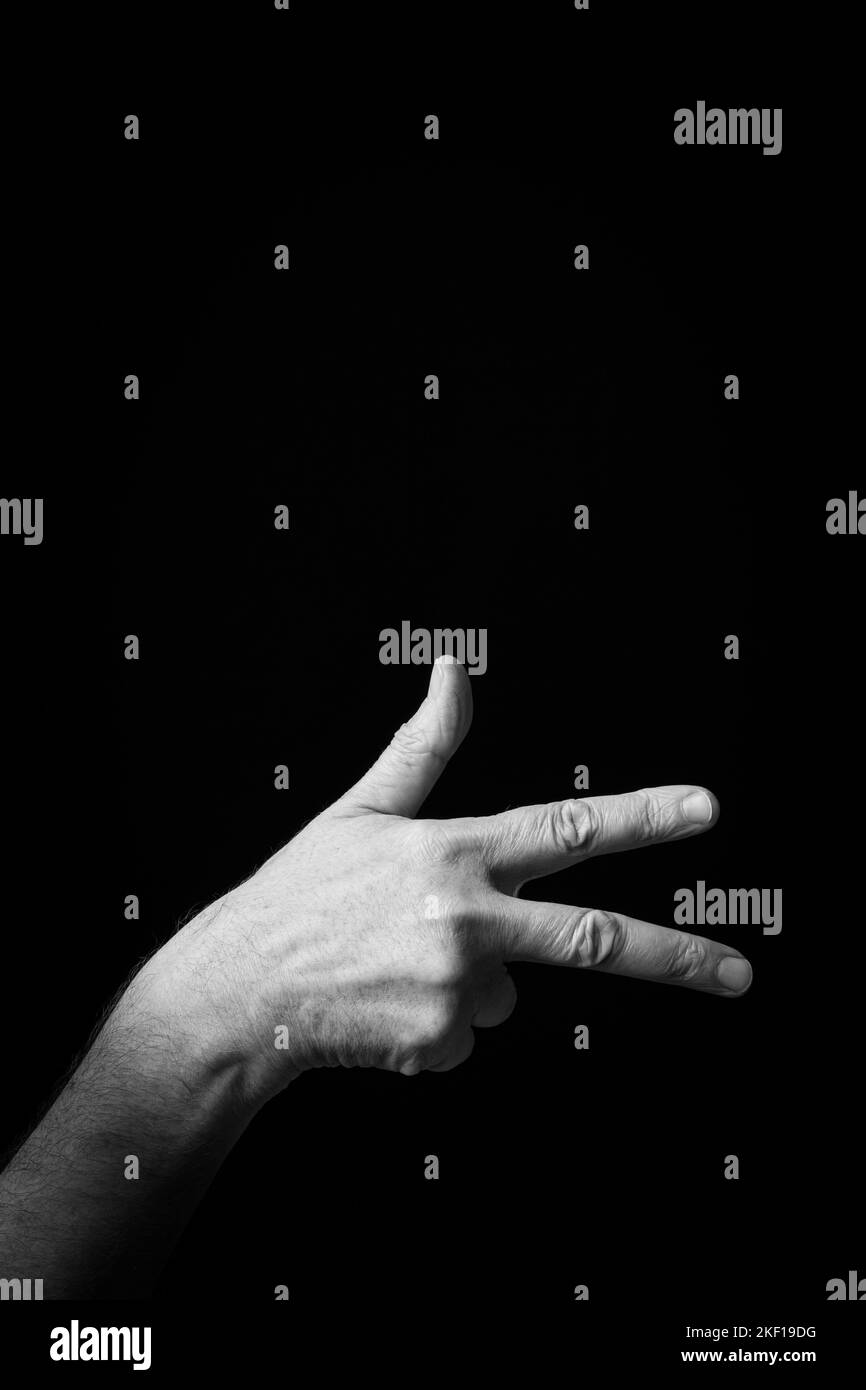 Dramatic black and white image of a male hand fingerspelling the Arabic ...