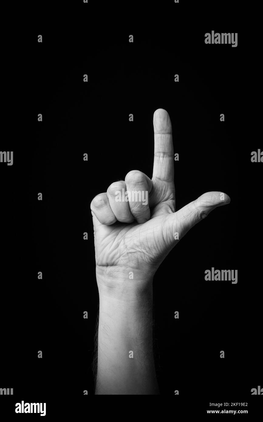 Dramatic black and white image of a male hand fingerspelling the Arabic ...