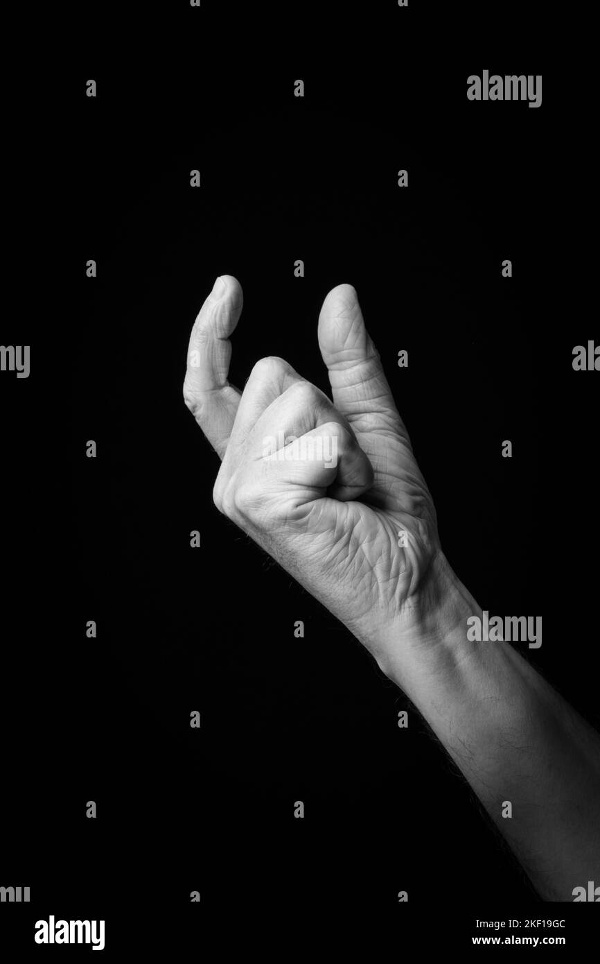 Dramatic black and white image of a male hand fingerspelling the Arabic ...