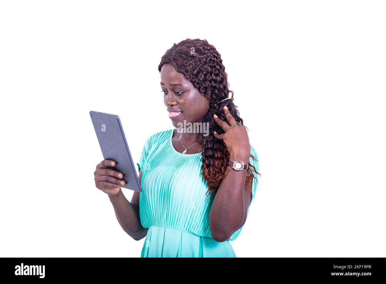 portrait beautiful young woman wearing green dress looking on screen of ...