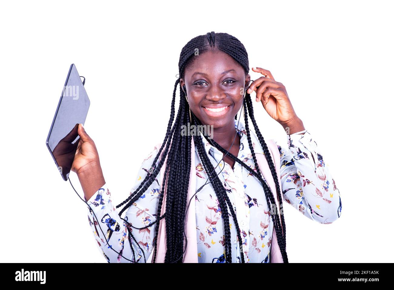 portrait of a beautiful young woman with headphones listening to music ...