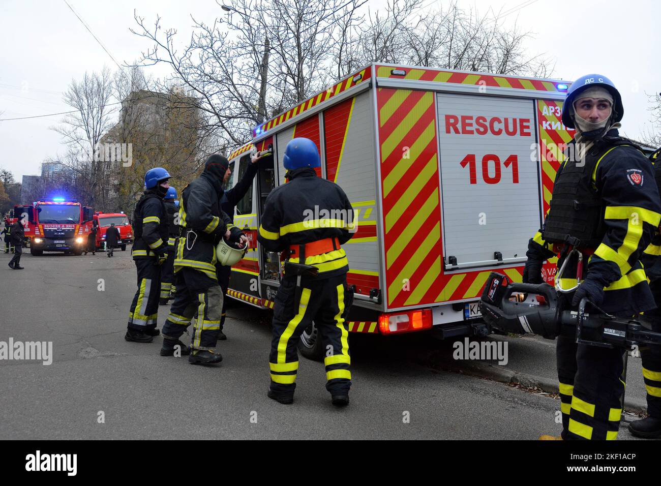 Firefighters work to put out a fire at a residential building hit by a ...