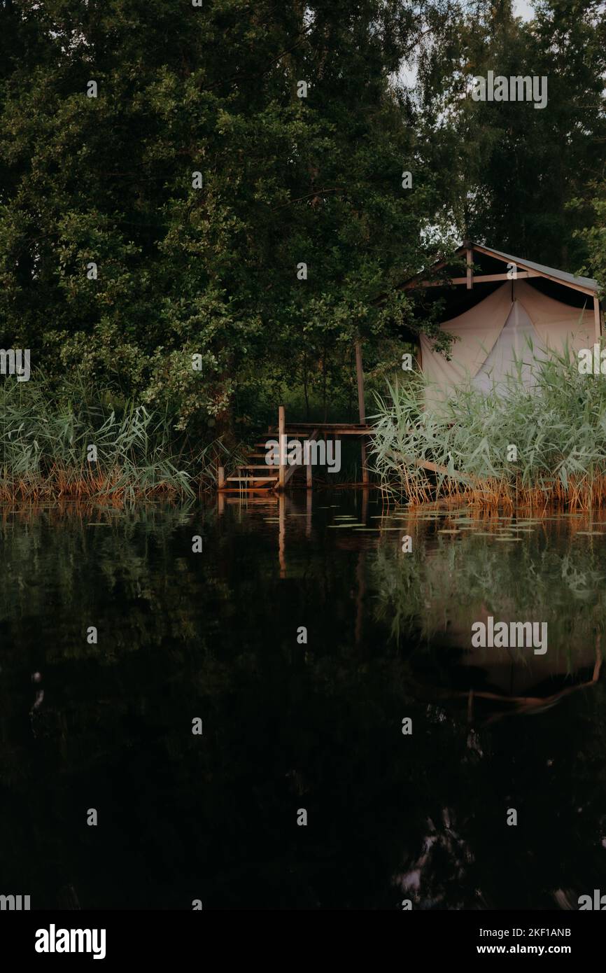 A nook hut on the lake in green forest Stock Photo - Alamy