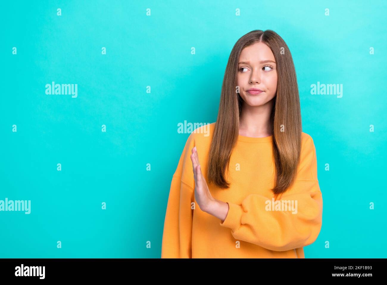 Photo of cute teenager girl look empty space wear yellow sweatshirt ...