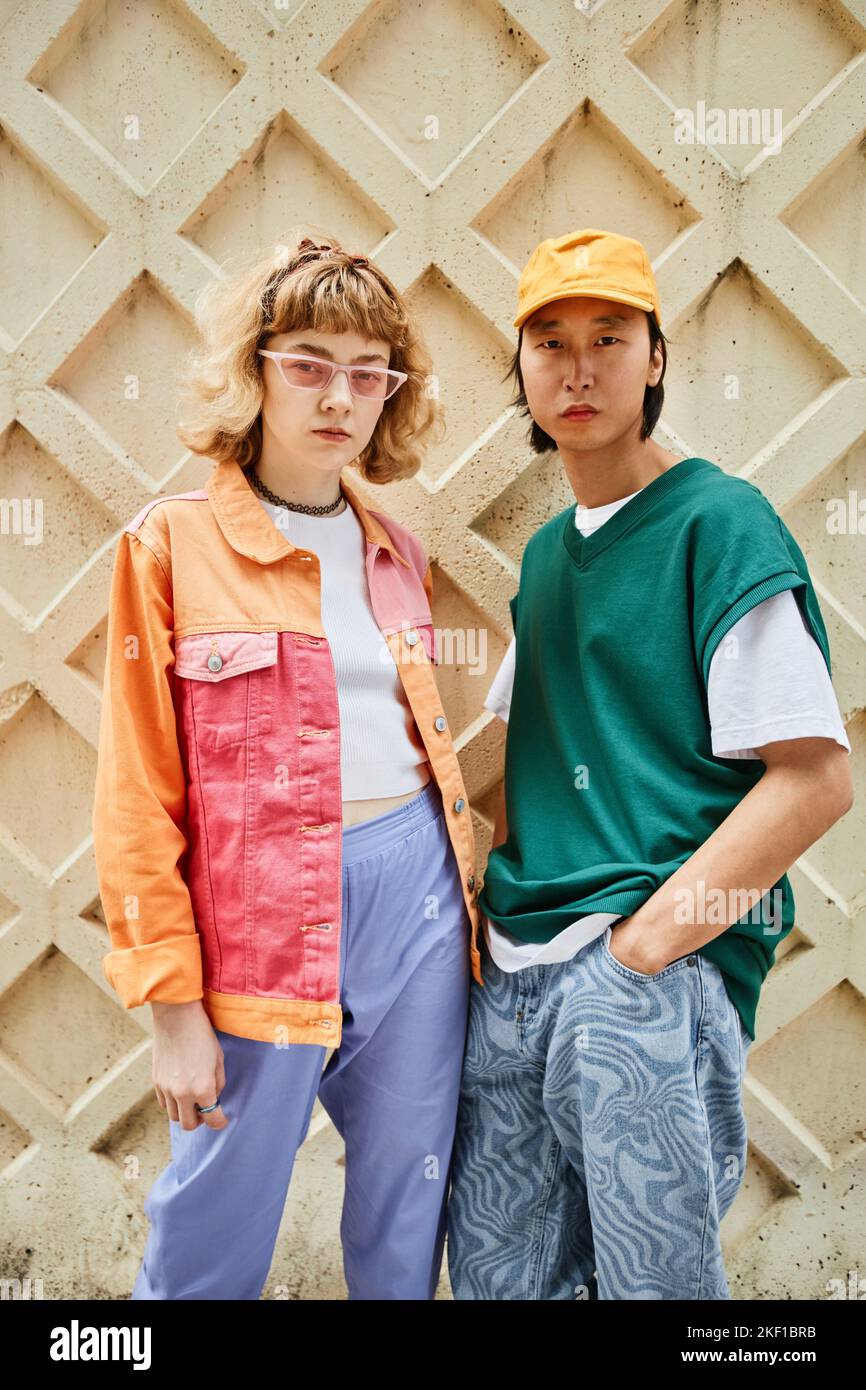 Vertical portrait of two young people wearing colorful street style ...