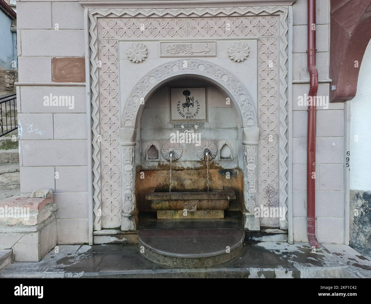 A horizontal image of fountain within an arc from light pink stone with ...