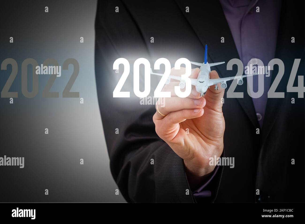 Finger pressing blue start 2023 button on virtual interface on gray ...