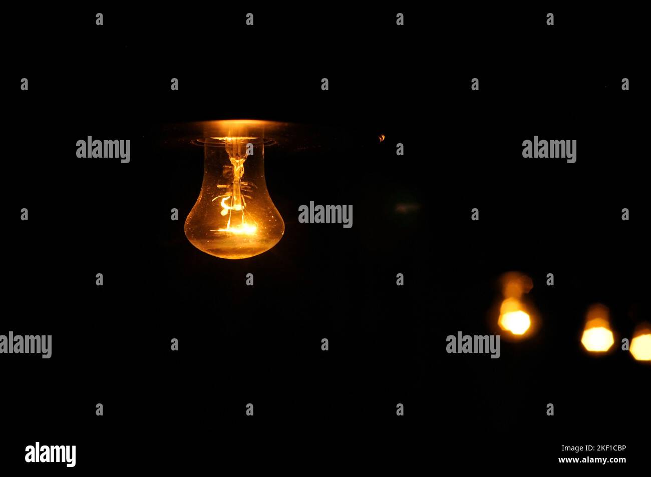 Electric light bulb shines dimly in the dark, creativity concept Stock ...