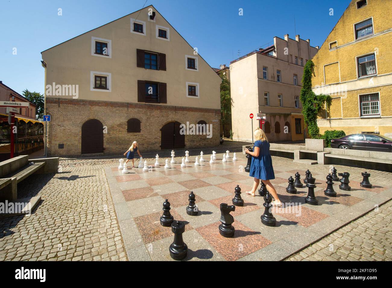 Klaipeda, Lithuania: A young cheerful woman holds a chess piece in her ...
