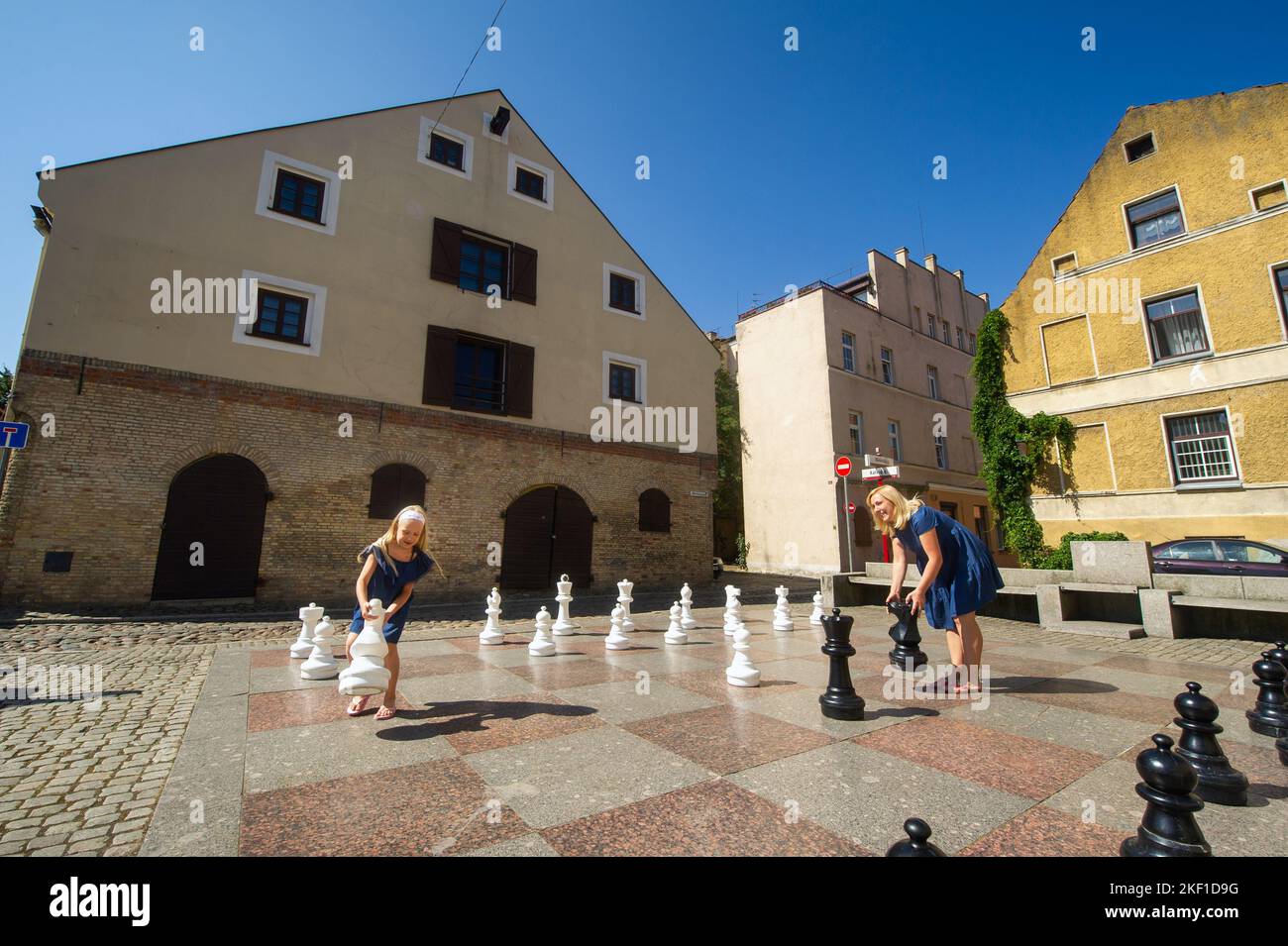 Klaipeda, Lithuania: A young cheerful woman holds a chess piece in her ...