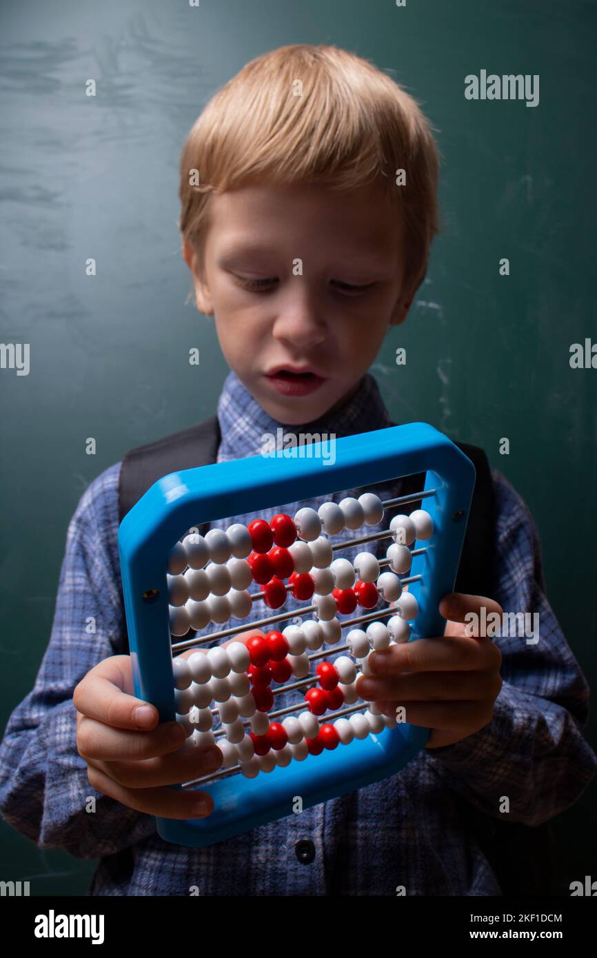 boy holding math with abacus at elementary school Stock Photo - Alamy