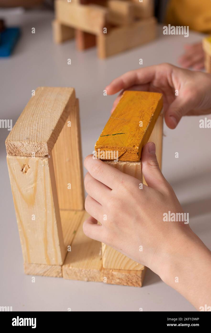 Wood bricks a child game, kids hands constructing Stock Photo - Alamy