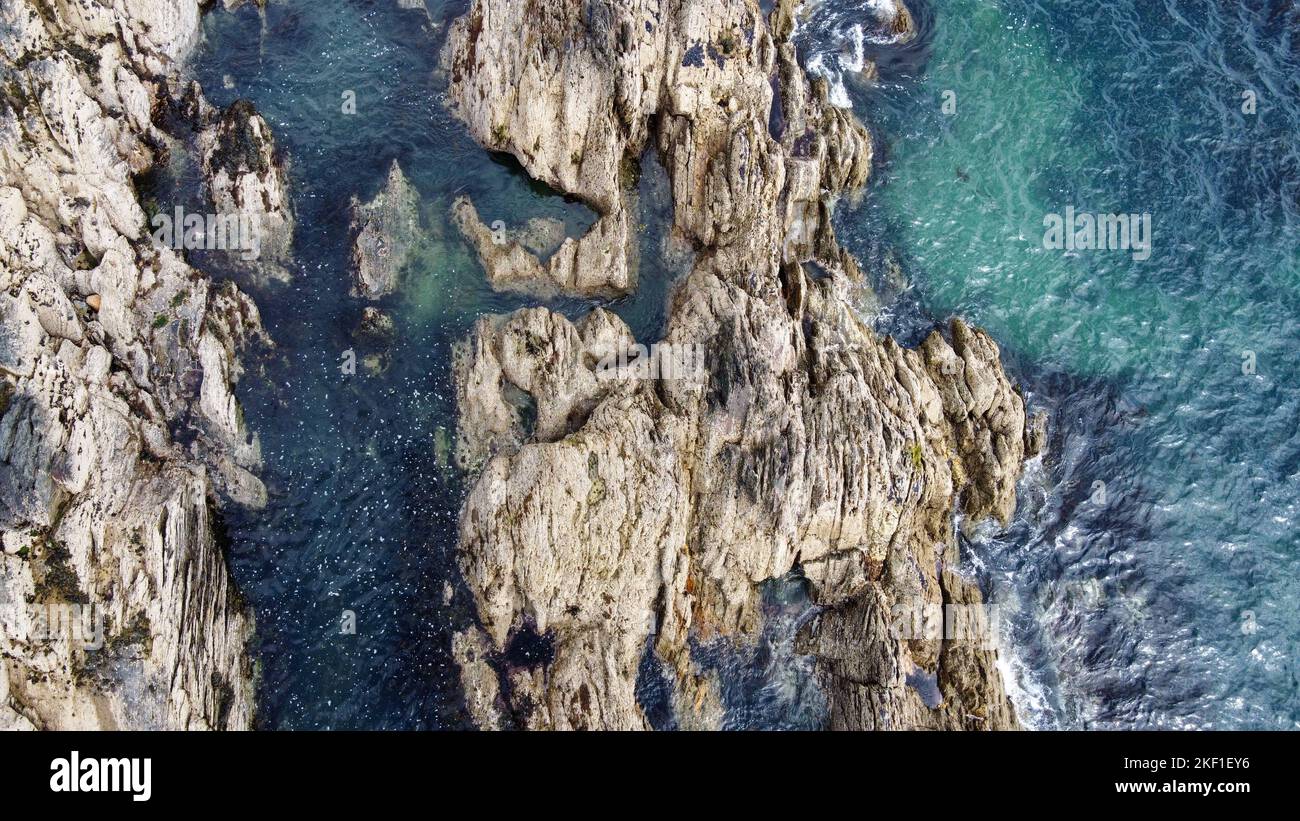 A lot of boulders in the sea water. Coastal cliffs of the North ...