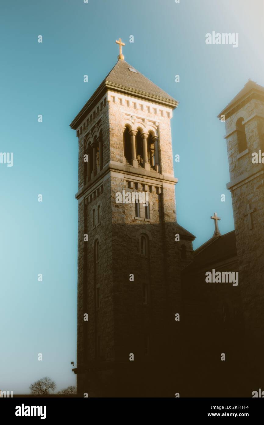 A vertical of a chapel tower with a cross on it Stock Photo - Alamy