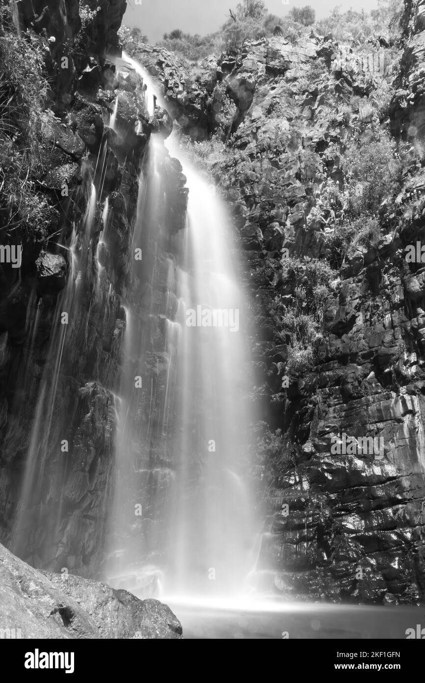 a vertical grayscale shot of a waterfall Stock Photo - Alamy