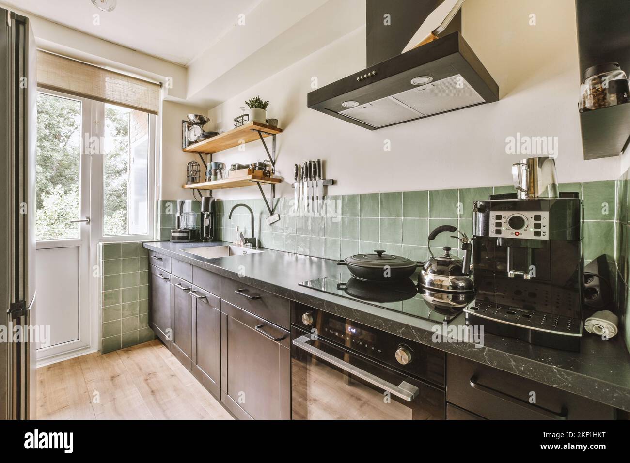 Fragment of interior of light narrow home kitchen with minimalist style ...
