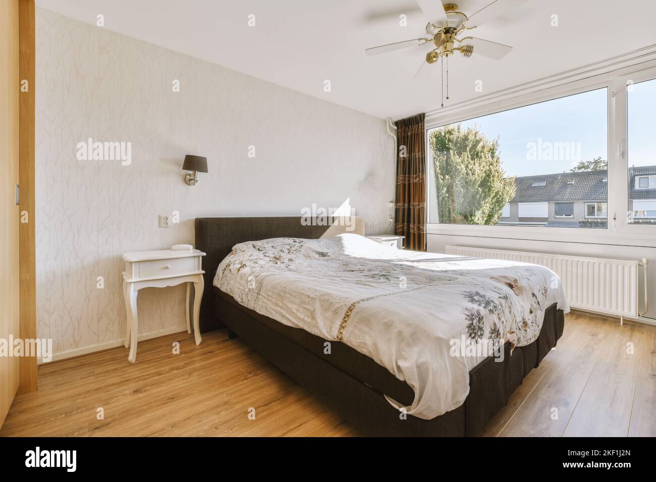 Home interior design of bedroom with bed and wooden wardrobe placed in ...