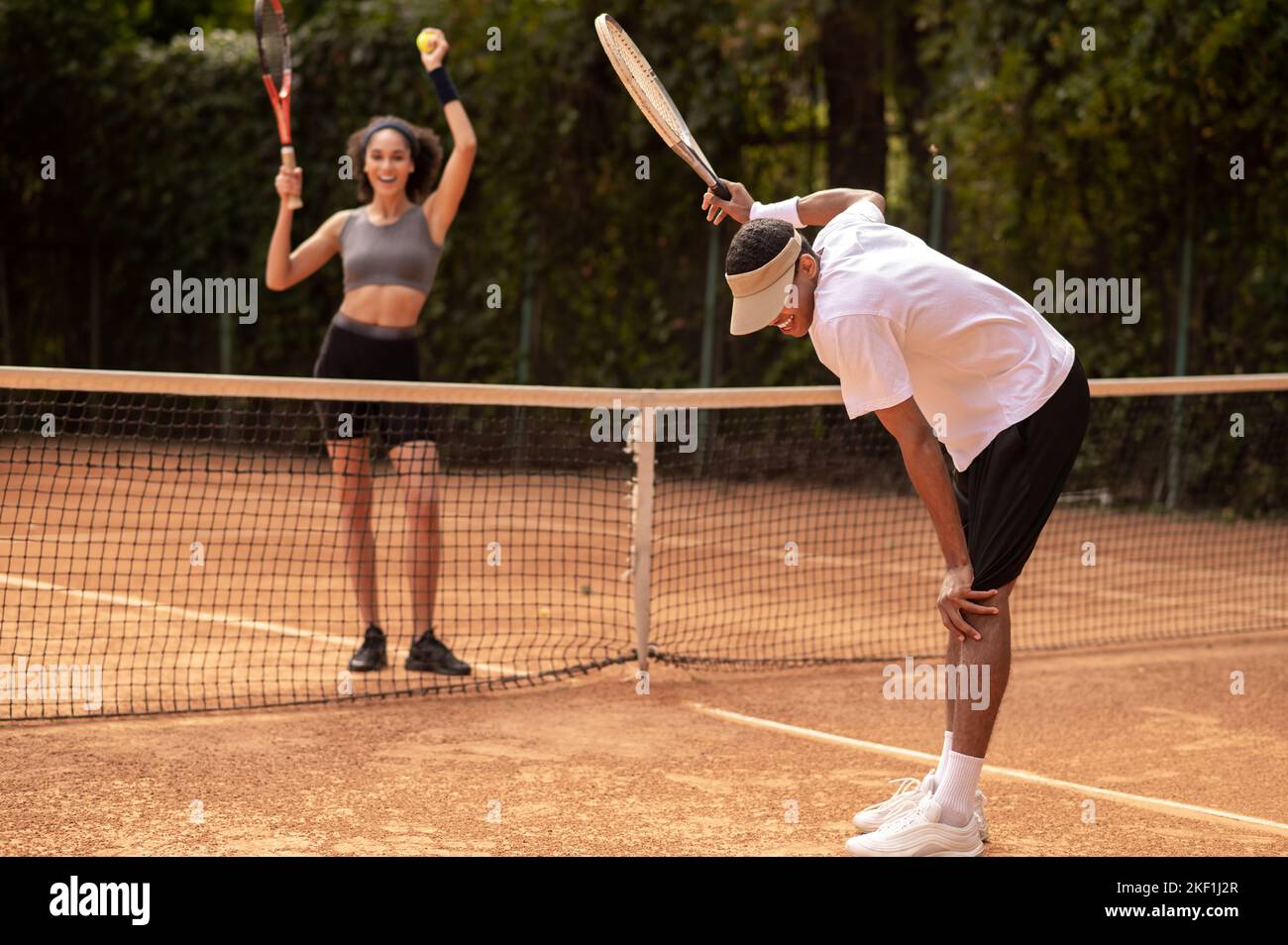Young people playing tennis at the tennis court Stock Photo - Alamy