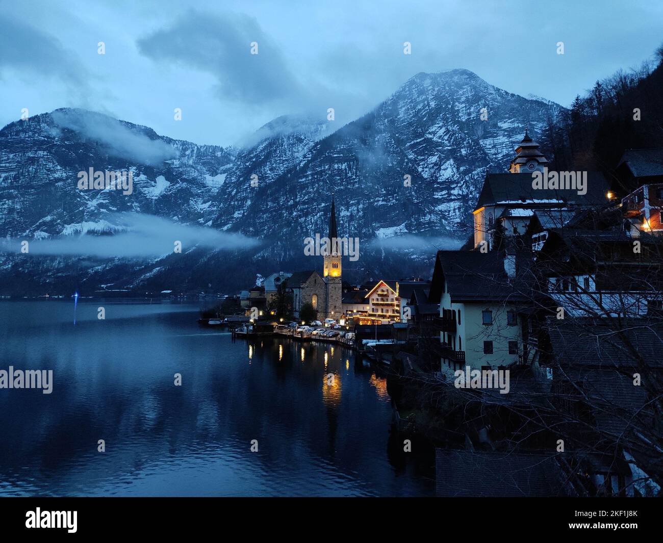 A high-angle of a Hallstatt wallpaper reflection with snowy, misty ...