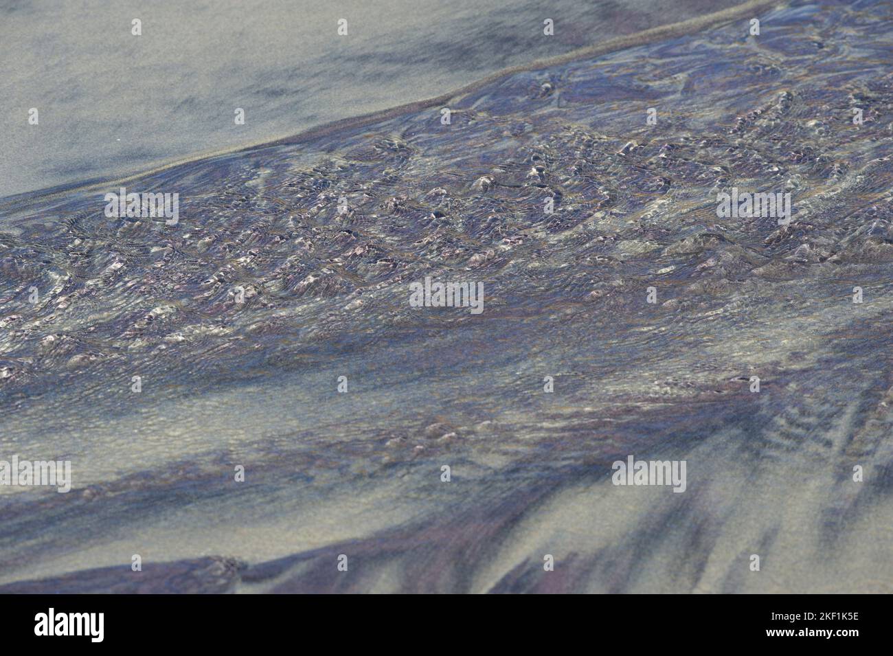 Sea Water trickling through sand Stock Photo - Alamy