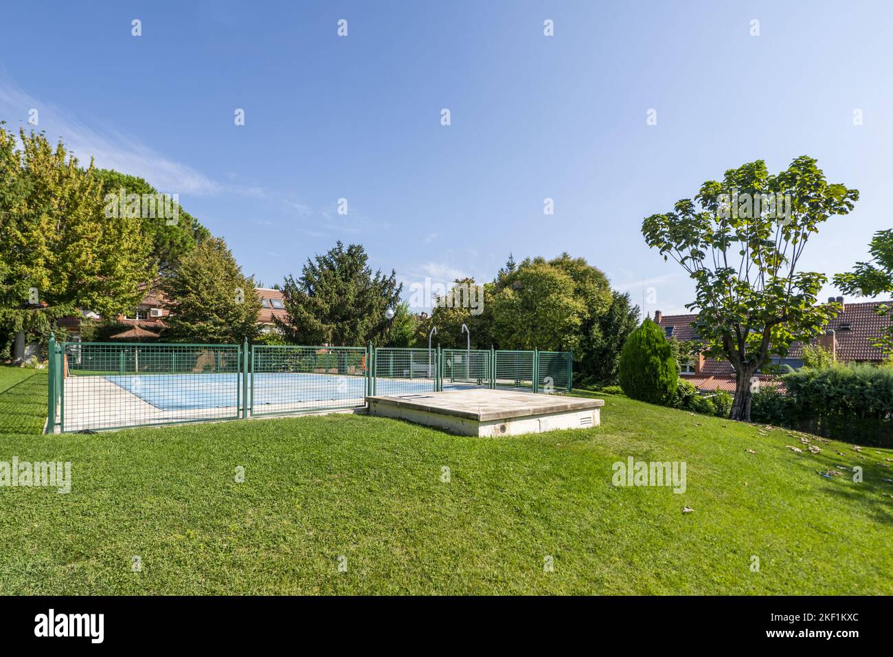 Covered swimming pool of an urbanization with many gardens and a lot of ...
