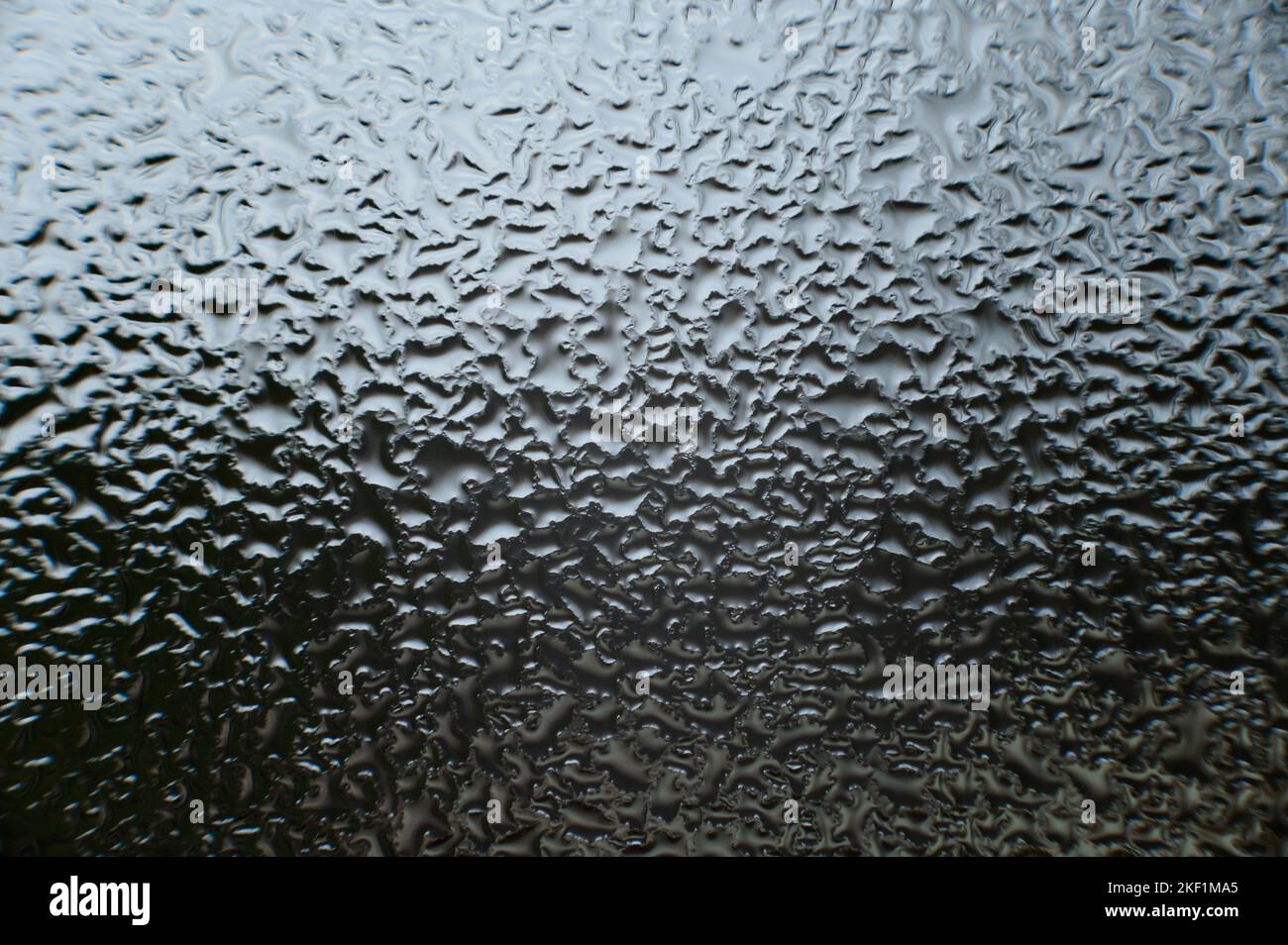 Close-up of condensation with water drops on the glass, texture of ...