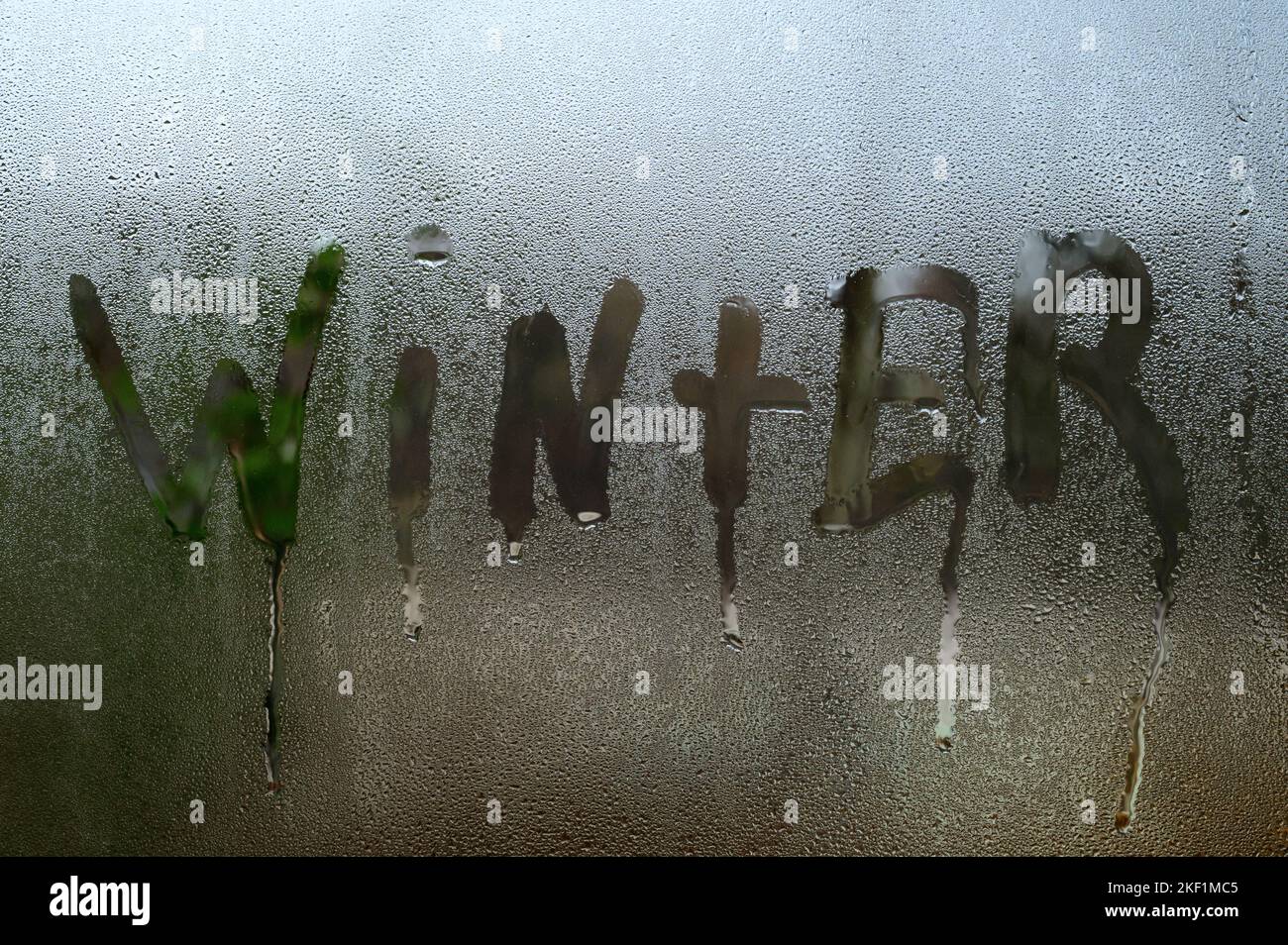 The inscription winter is painted on glass with condensation, the ...