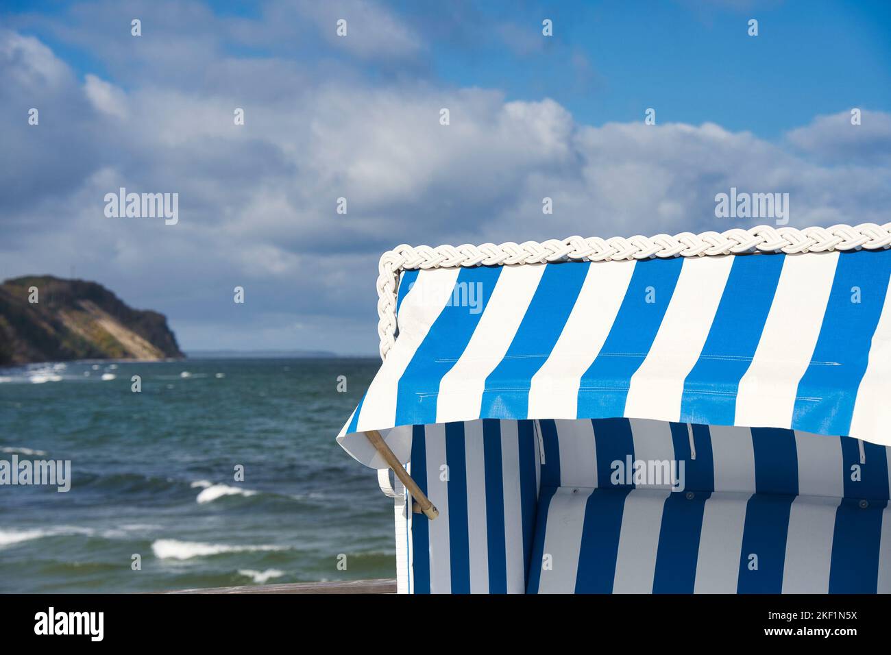A selective focus of a beach chair with blue and white stripes with the ...