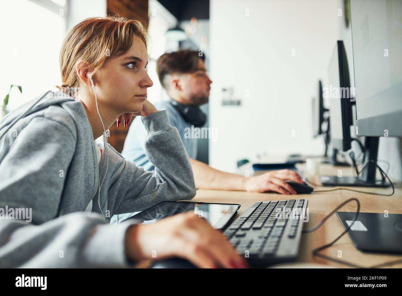 Students learning in computer classroom. Young man preparing for test ...