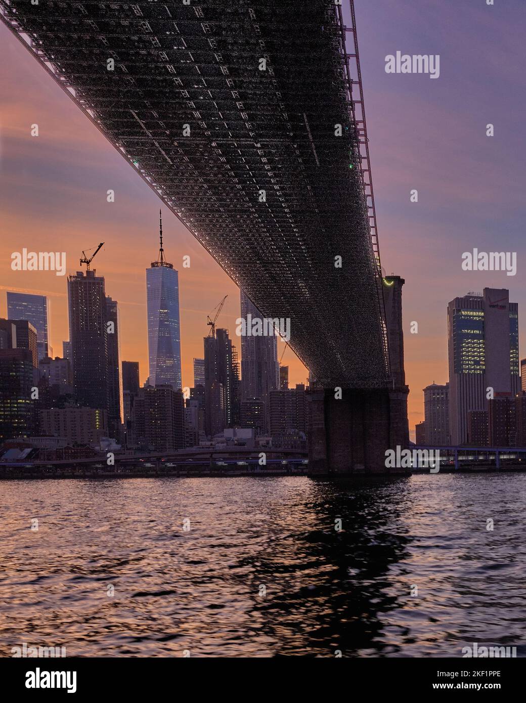 View of the Manhattan Bridge from below at sunset, showing the sky line ...