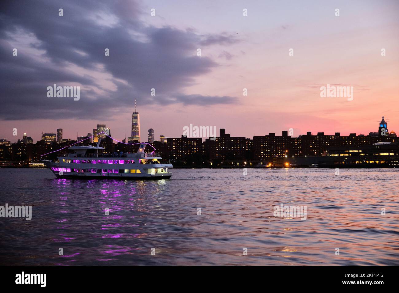 Cruise with purple lights in Hudson River with the illuminated New York ...