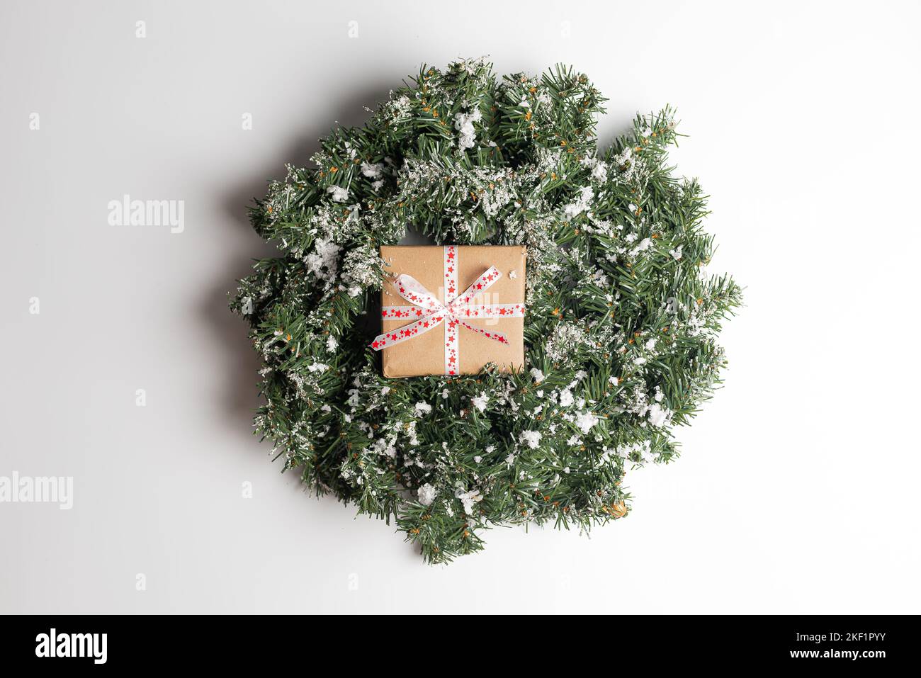 Christmas wreath with gift box on white background Stock Photo - Alamy