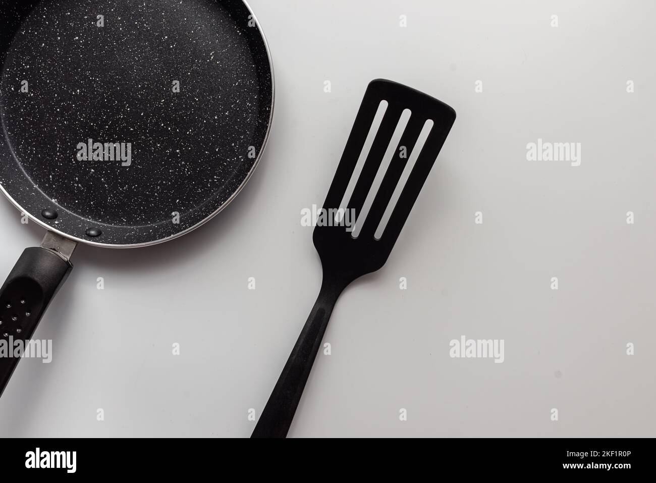 Top view frying pan and plastic spatula on white background Stock Photo ...