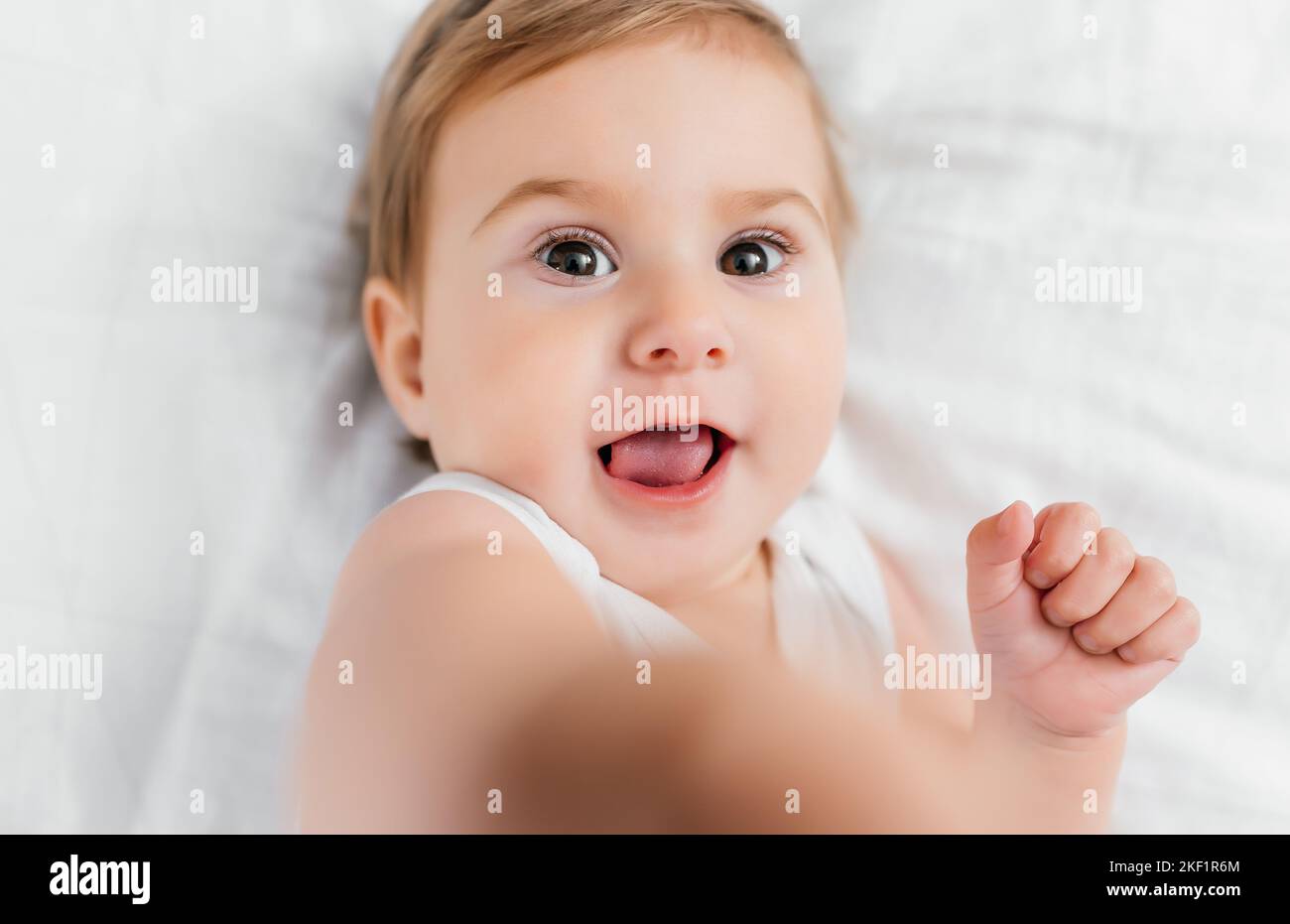 Happy baby girl 8 month look at the camera Stock Photo - Alamy