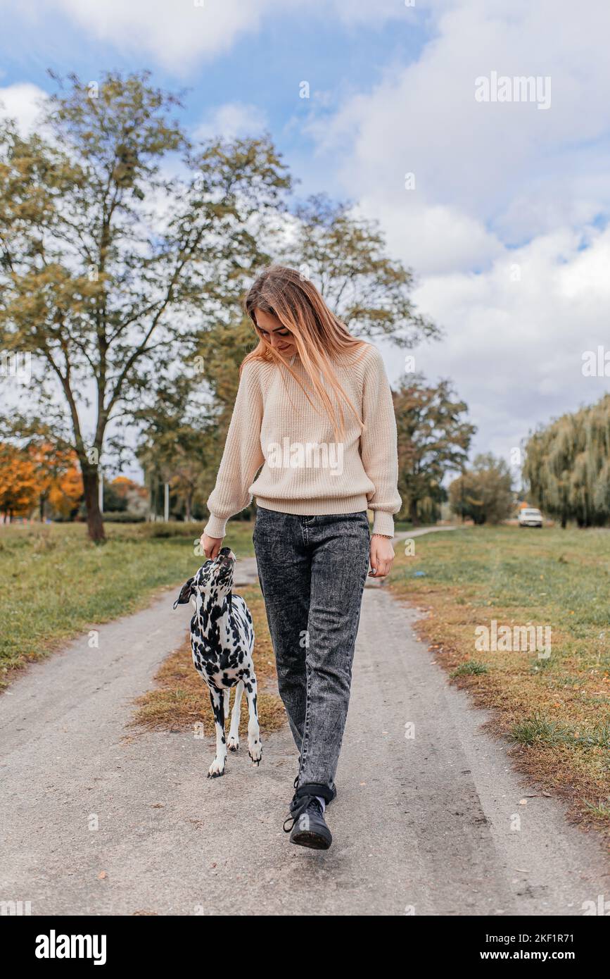 Girl walking with her dog in the park Stock Photo - Alamy