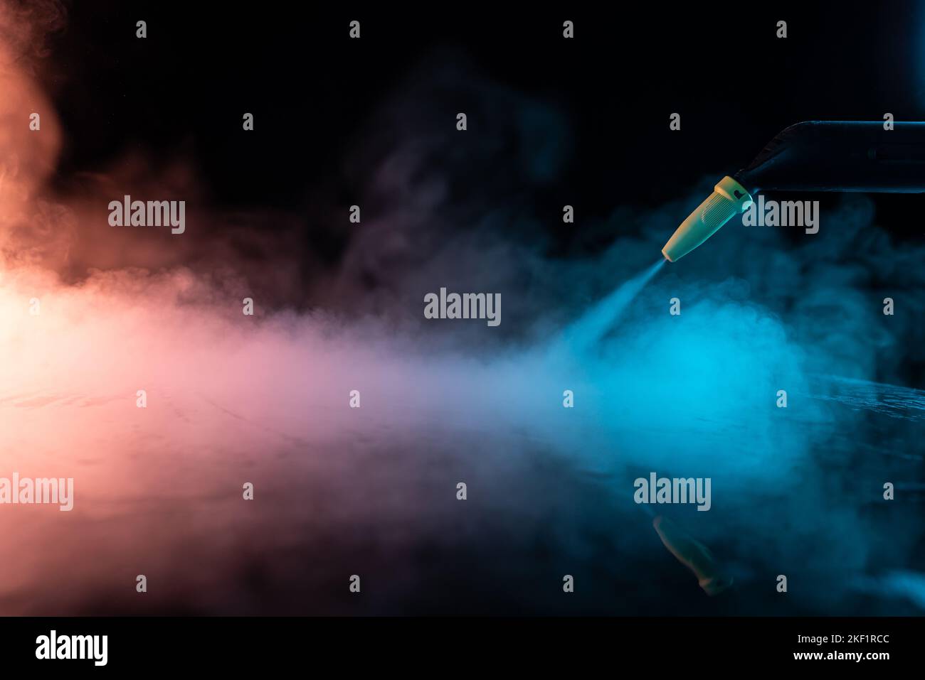 steam cleaning concept. steam on black background Stock Photo - Alamy