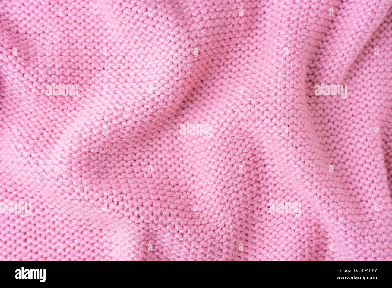 Close up background of knitted wool fabric made of viscose yarn. Bright ...