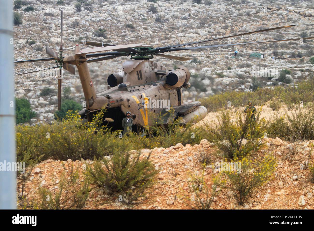 An Israeli military helicopter transports injured people at the site of ...