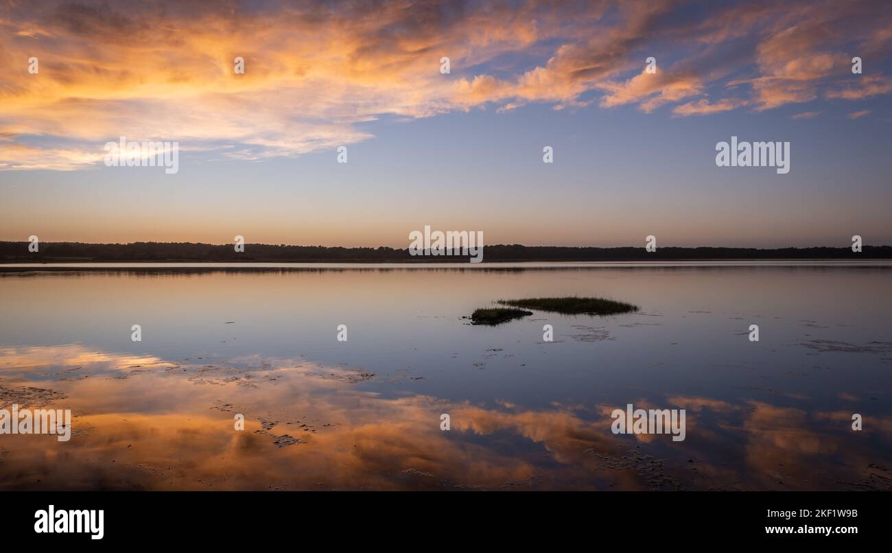 Sun setting over harbour in Dorset UK Stock Photo - Alamy