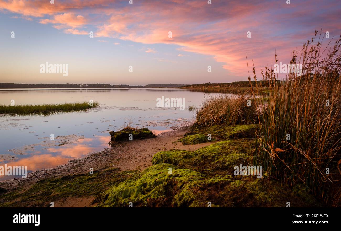 Sun setting over harbour in Dorset UK Stock Photo - Alamy
