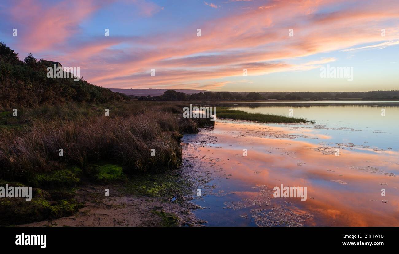 Sun setting over harbour in Dorset UK Stock Photo - Alamy